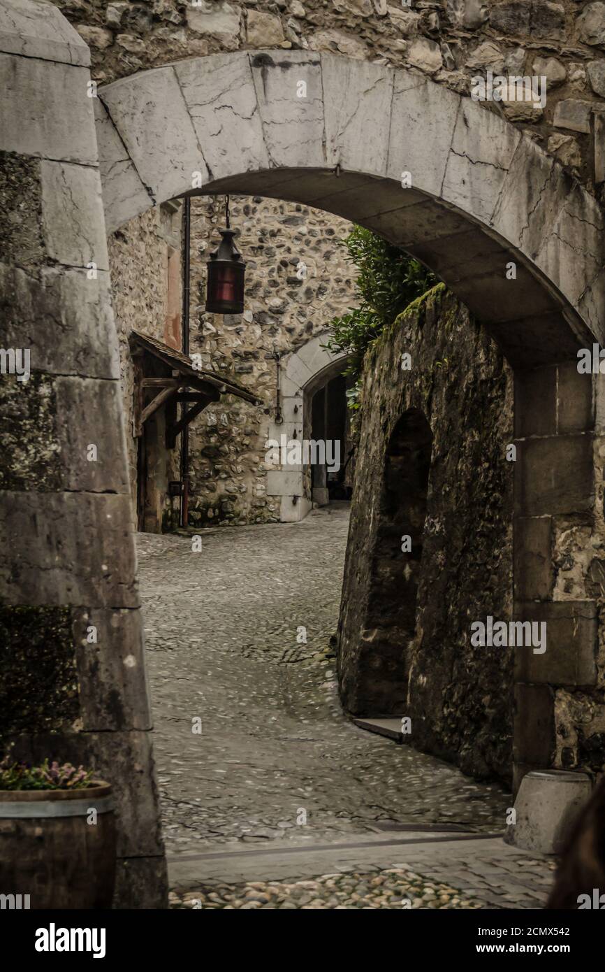 Arched corridor over a curved stone pathway in a old castle Stock Photo ...