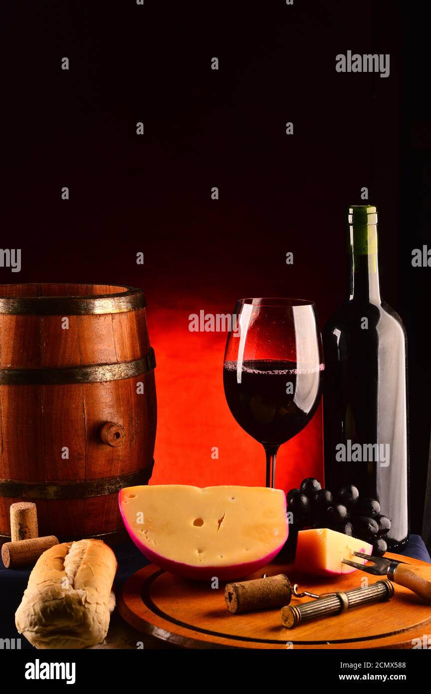 Glass of red wine with cheese, bread and a wooden barrel nearby Stock ...