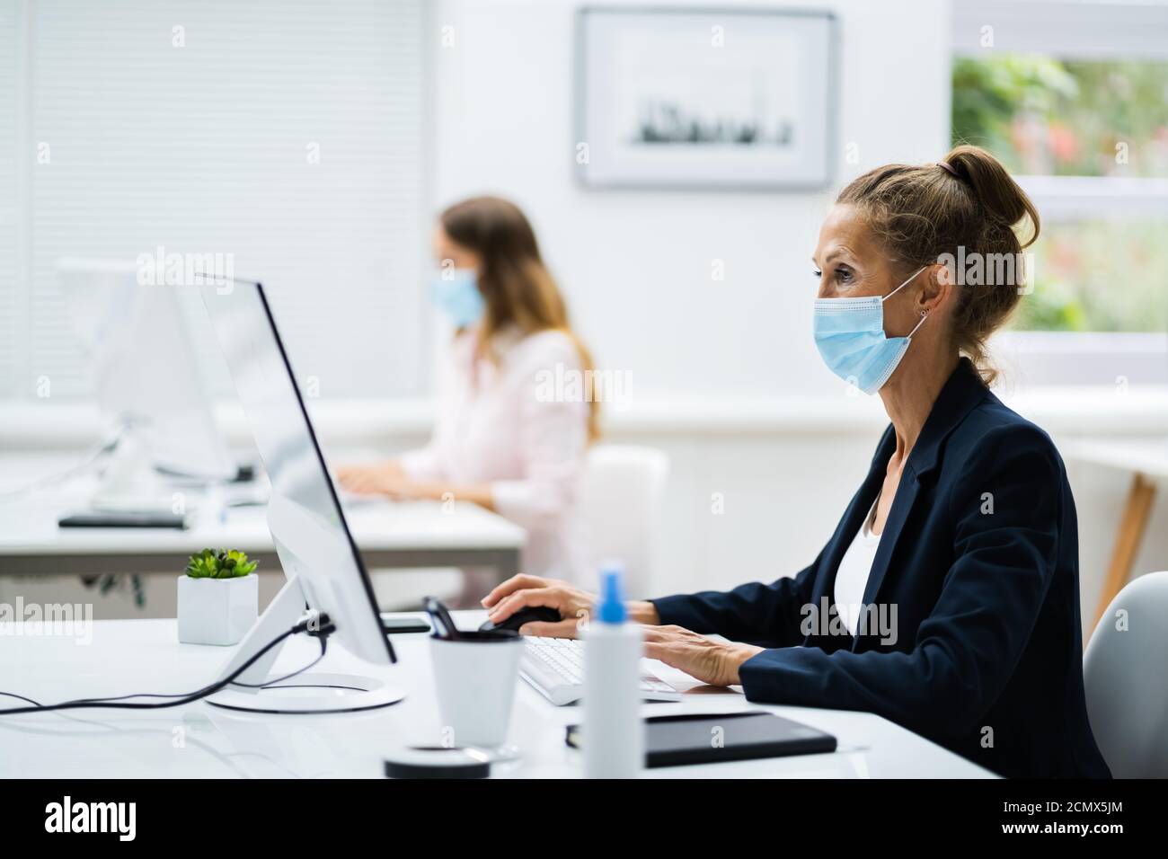 Business Team Training. Working On Computer With Face Mask Stock Photo ...