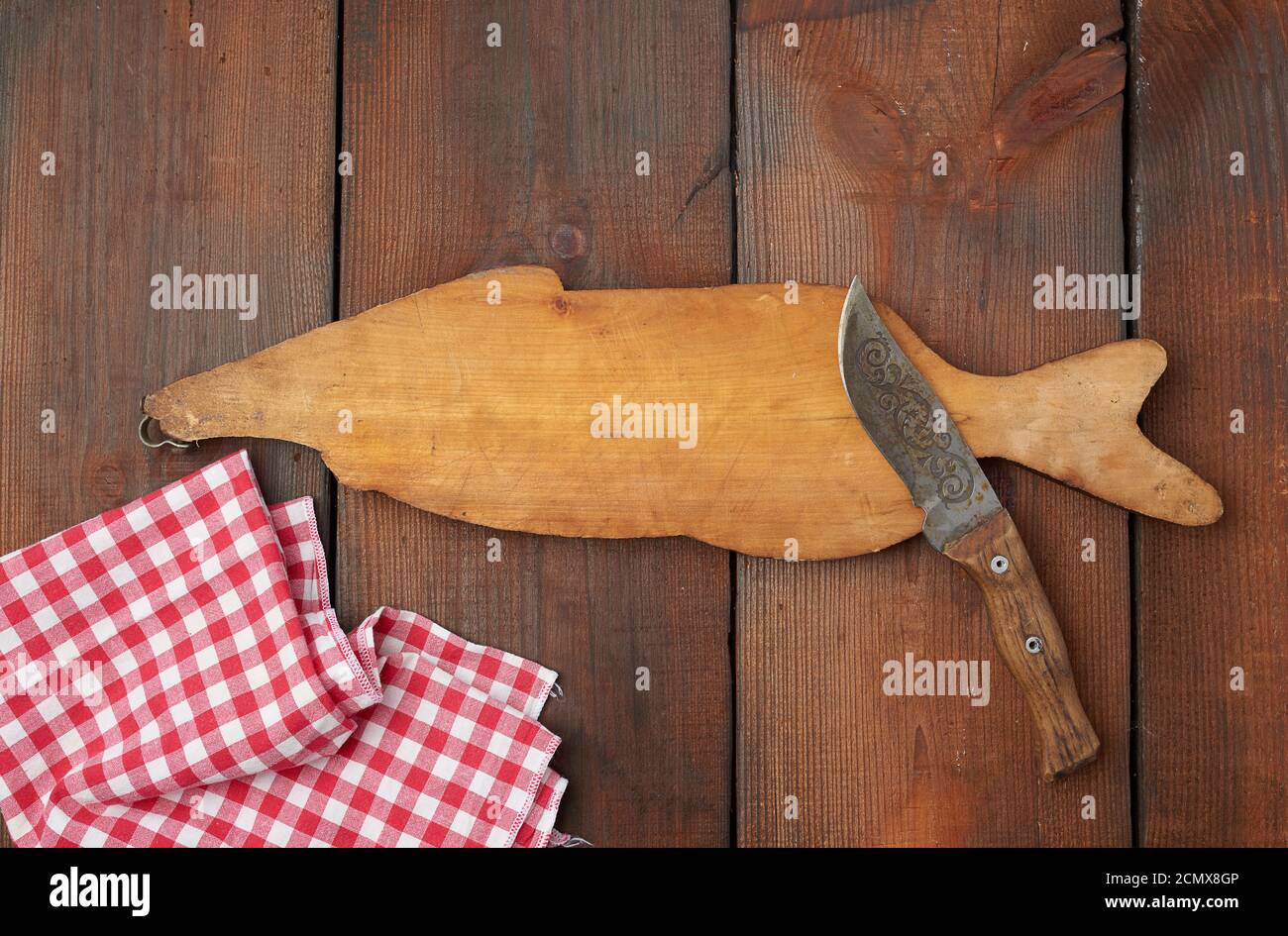 wooden cutting board in the shape of a fish and a sharp knife Stock ...