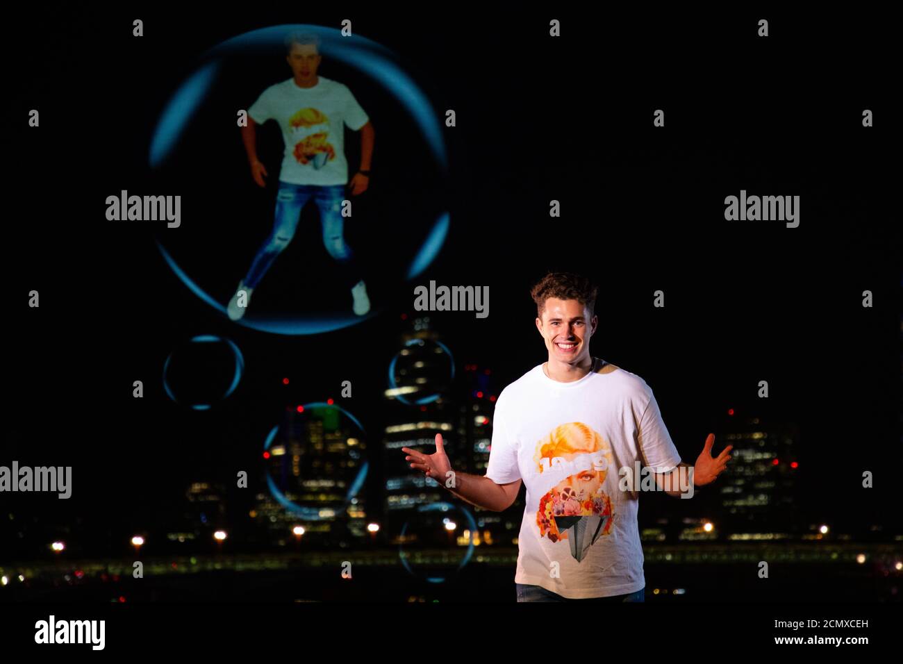 EDITORIAL USE ONLY Curtis Pritchard watches a hologram of himself in ...