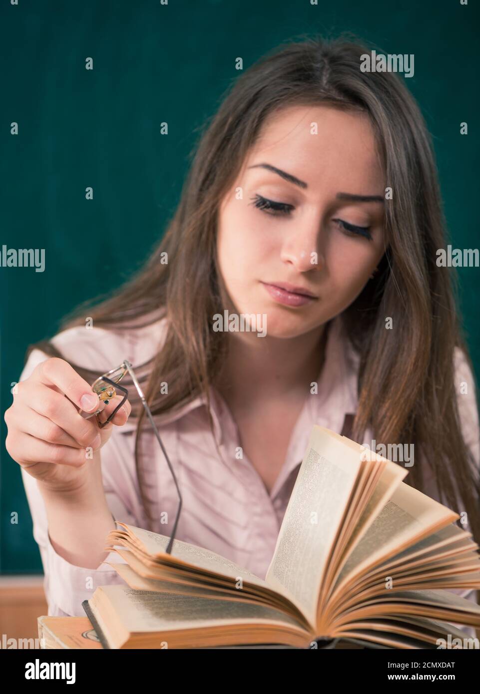 young woman teacher portrait at classroom with open books Stock Photo ...