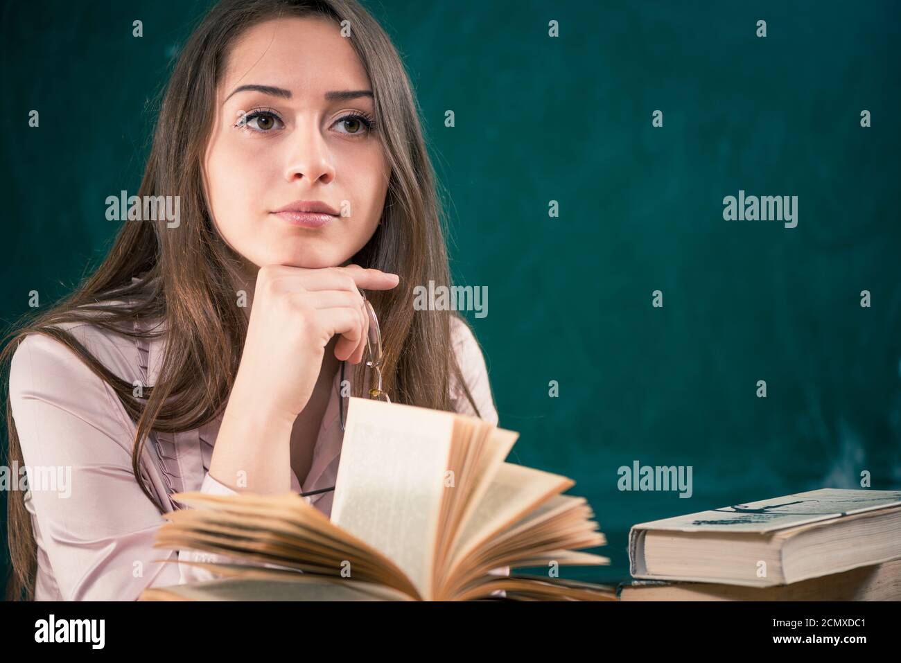 young woman teacher portrait at classroom with open books Stock Photo ...