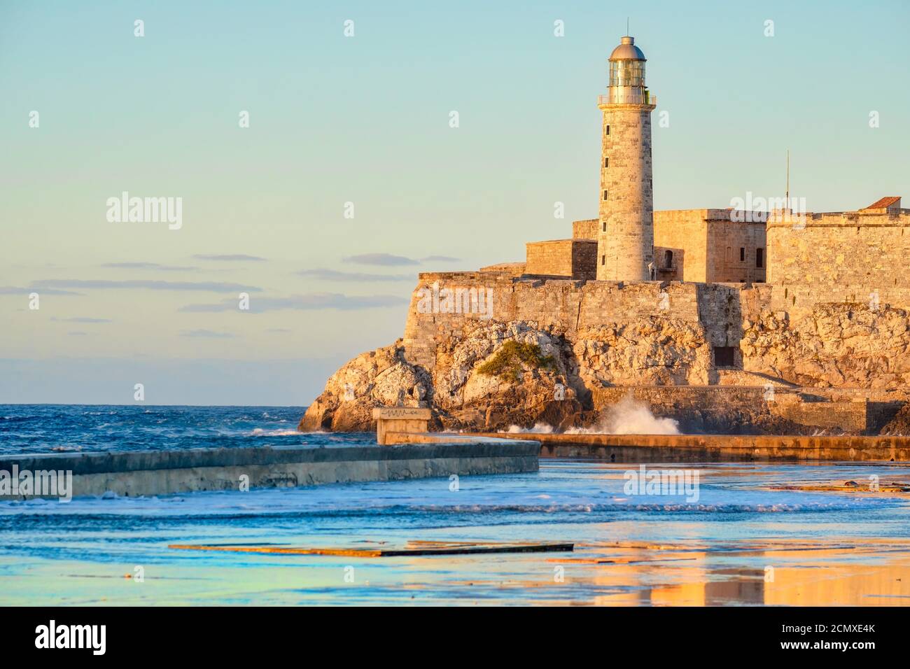 El morro fortress and lighthouse at sunset , a symbol of the city of ...