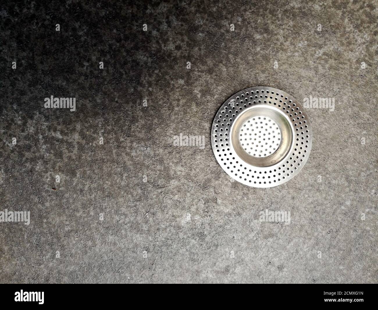 Top view of a stainless steel sink strainer on a gray background Stock ...