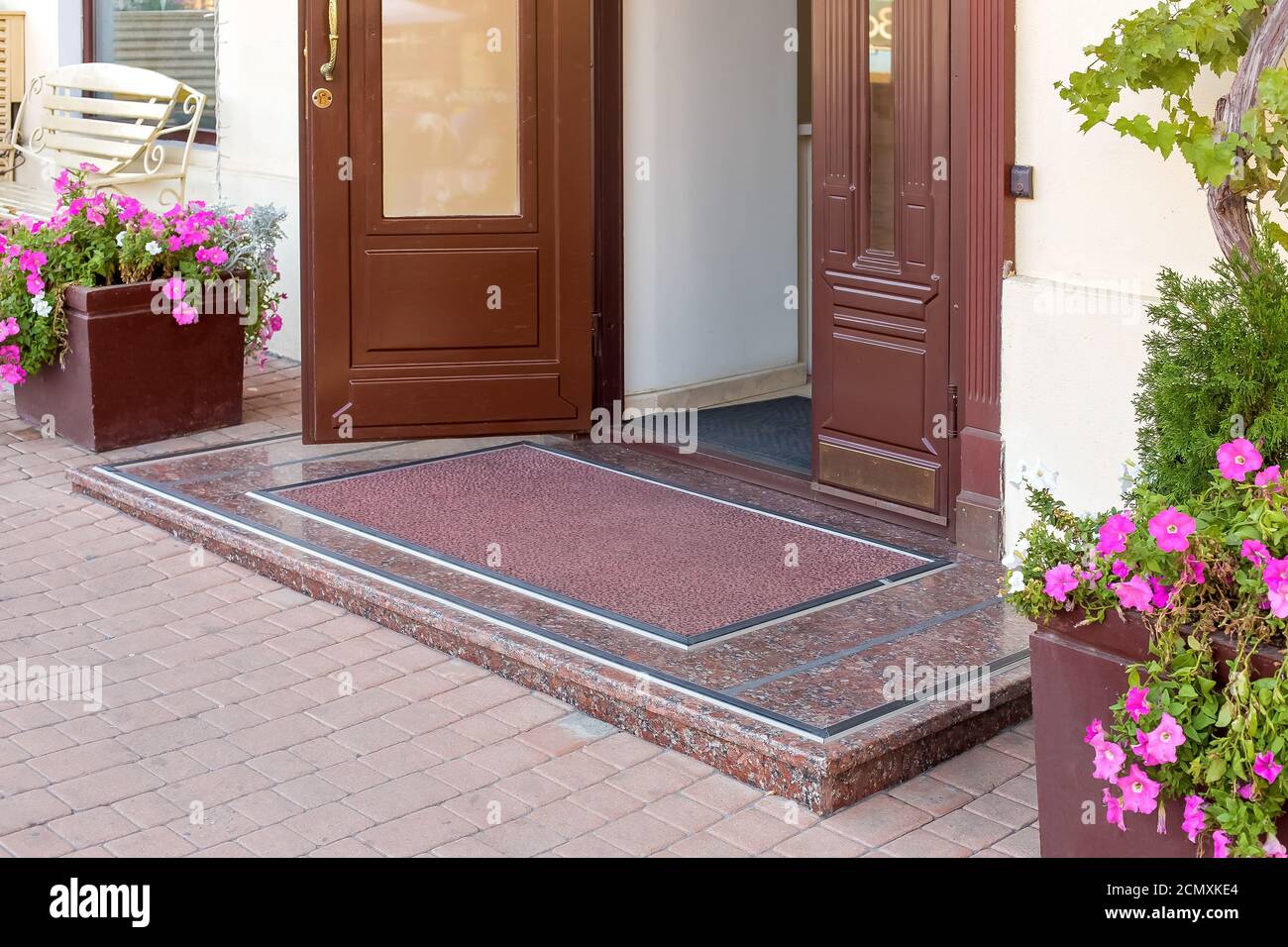 threshold with mat on entrance door in hotel on facade of building ...