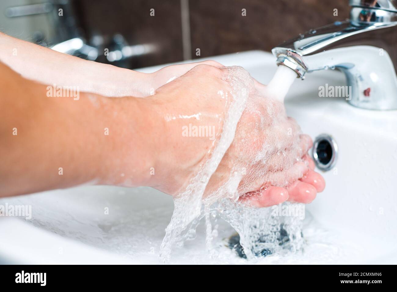 Washing hands under the water tap or faucet without soap. Hygiene ...