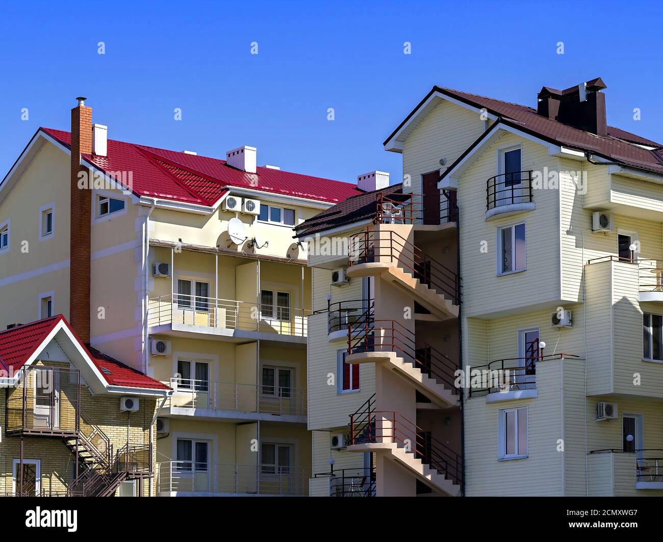 three-storey hotel decorated with beige siding Stock Photo - Alamy