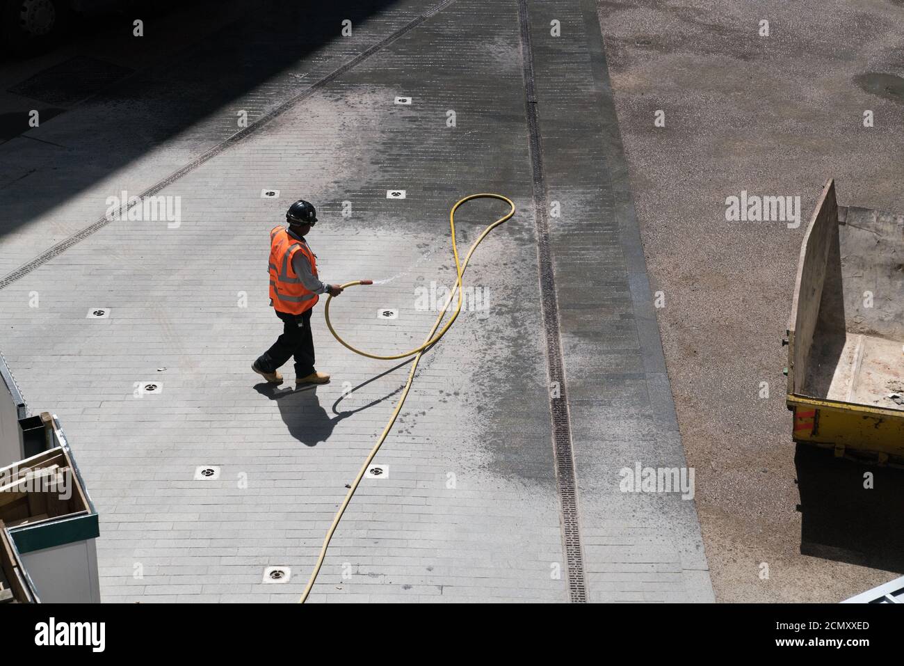 worker spraying water Stock Photo - Alamy