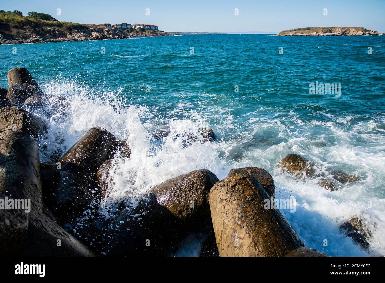 Close up of rocks and waves crashing on them. Water splashing on the ...