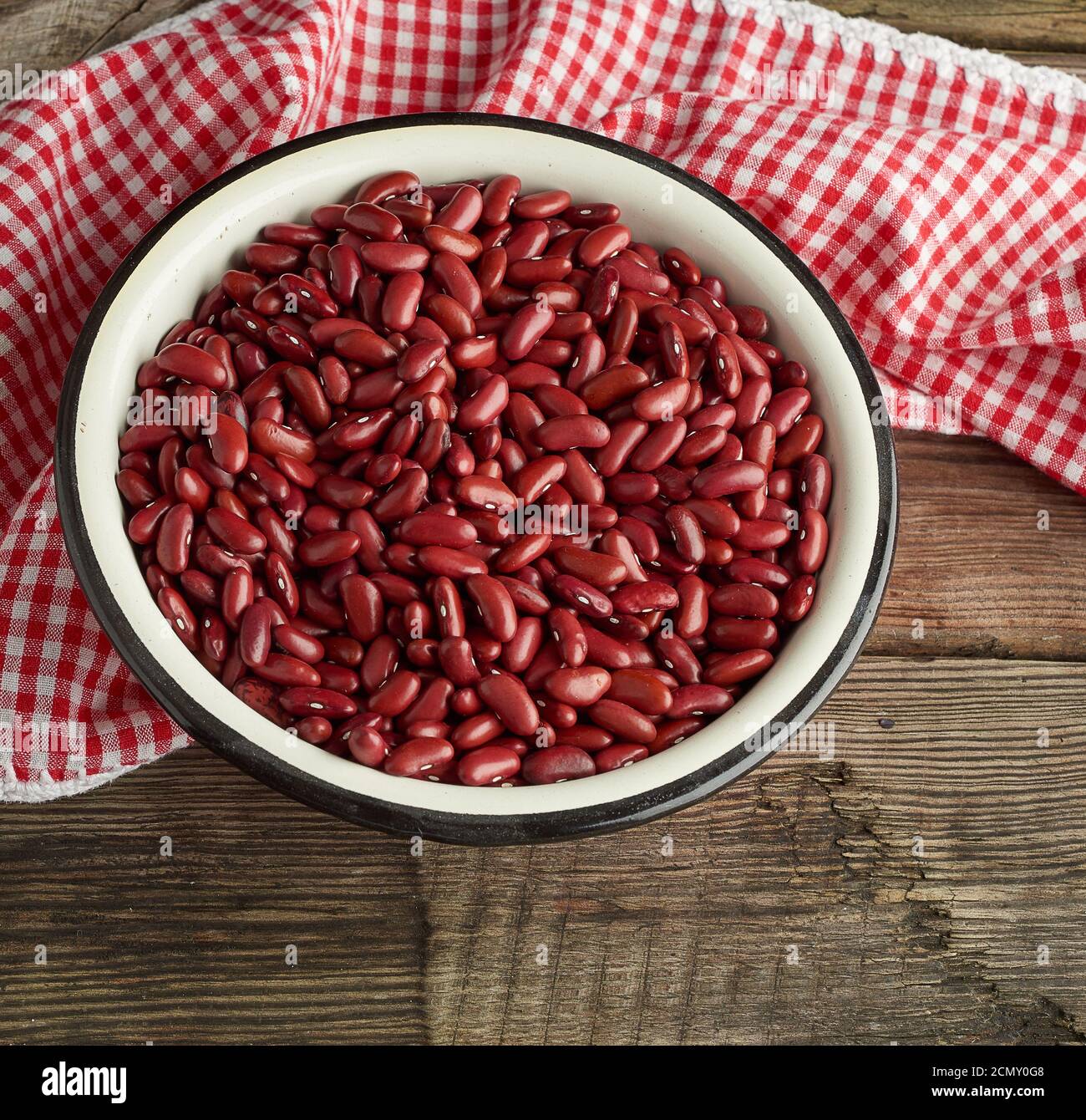 raw oval red beans in a plate on a wooden table Stock Photo - Alamy
