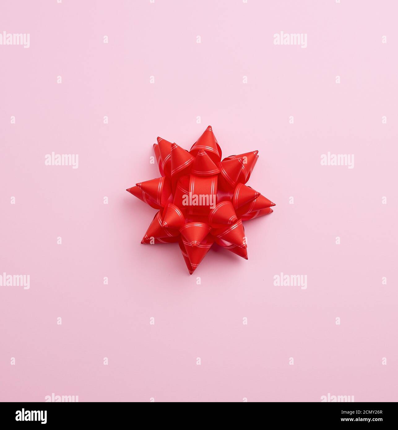 red beautiful bow on a pink background Stock Photo - Alamy