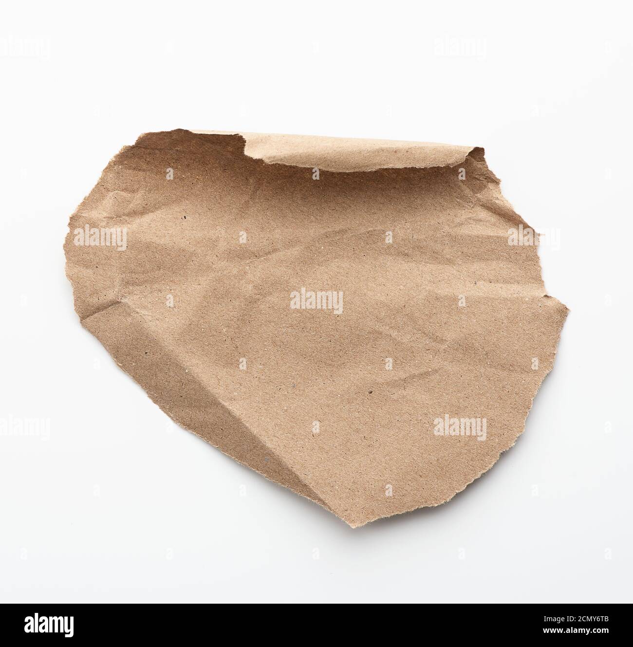 round piece of brown paper paper with torn edges on a white background ...
