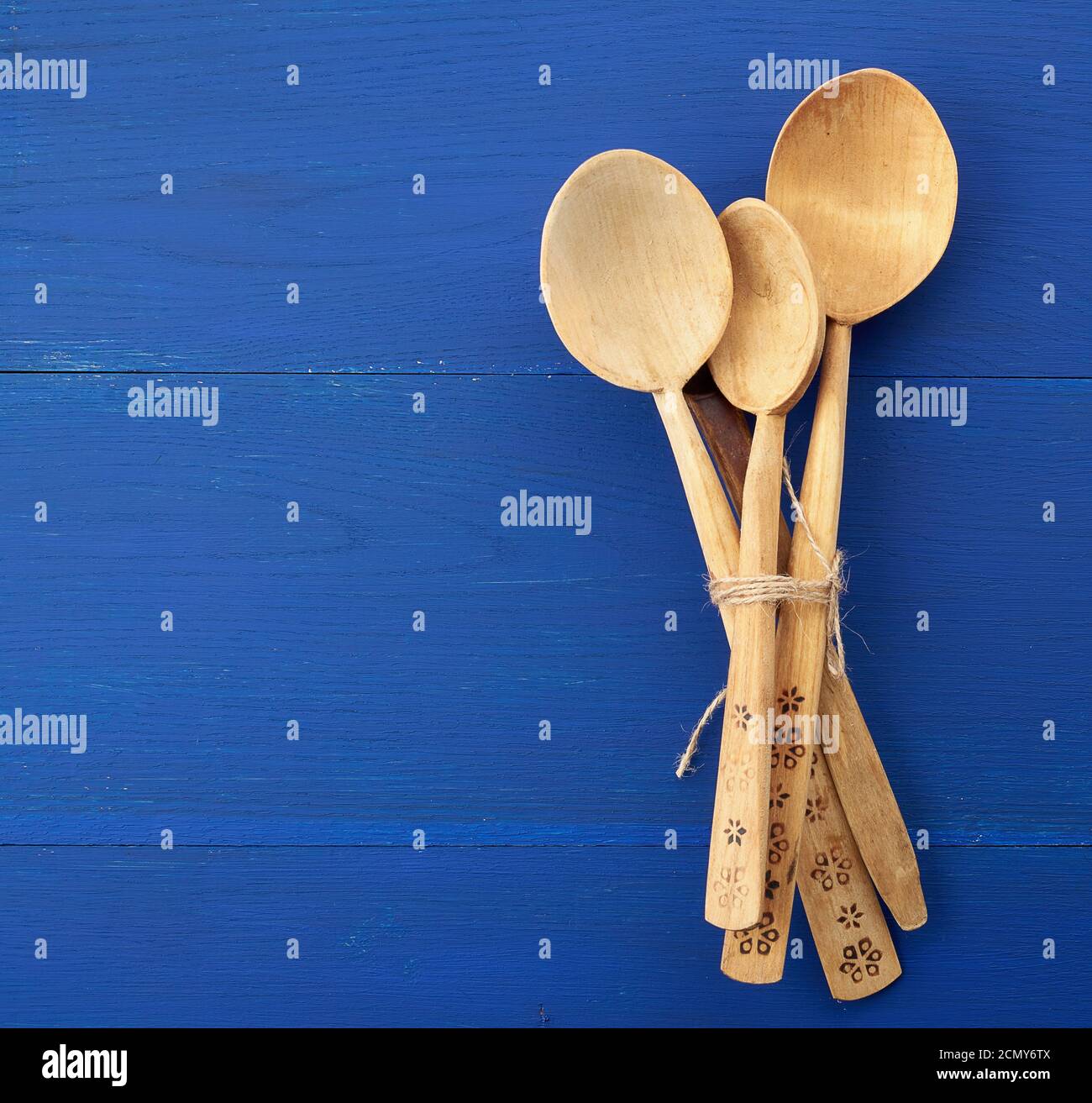 set of wooden vintage spoons tied with brown rope Stock Photo - Alamy