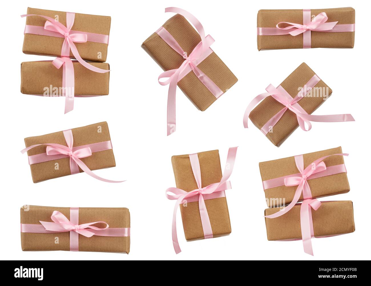 rectangular boxes wrapped in brown kraft paper and tied with a pink ...