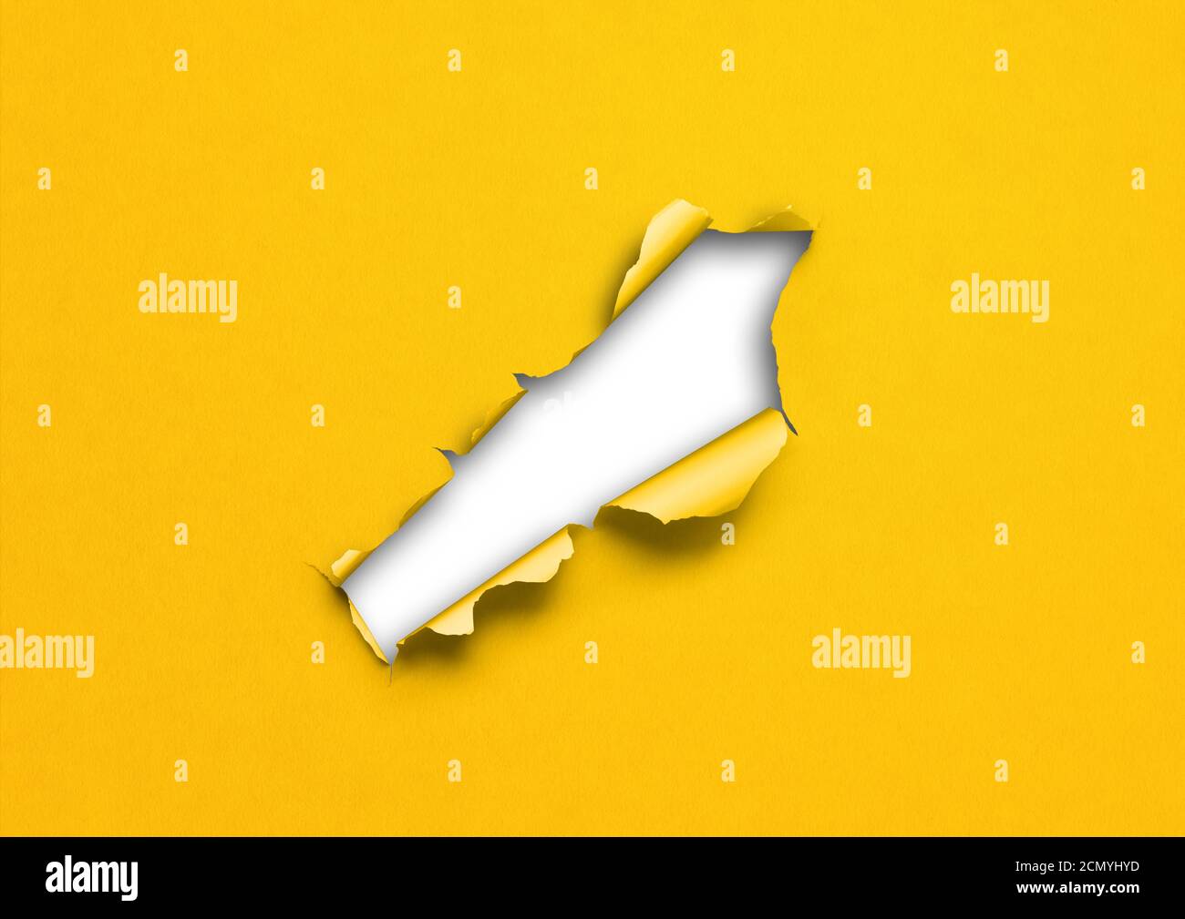 Yellow torn paper with hole Stock Photo - Alamy