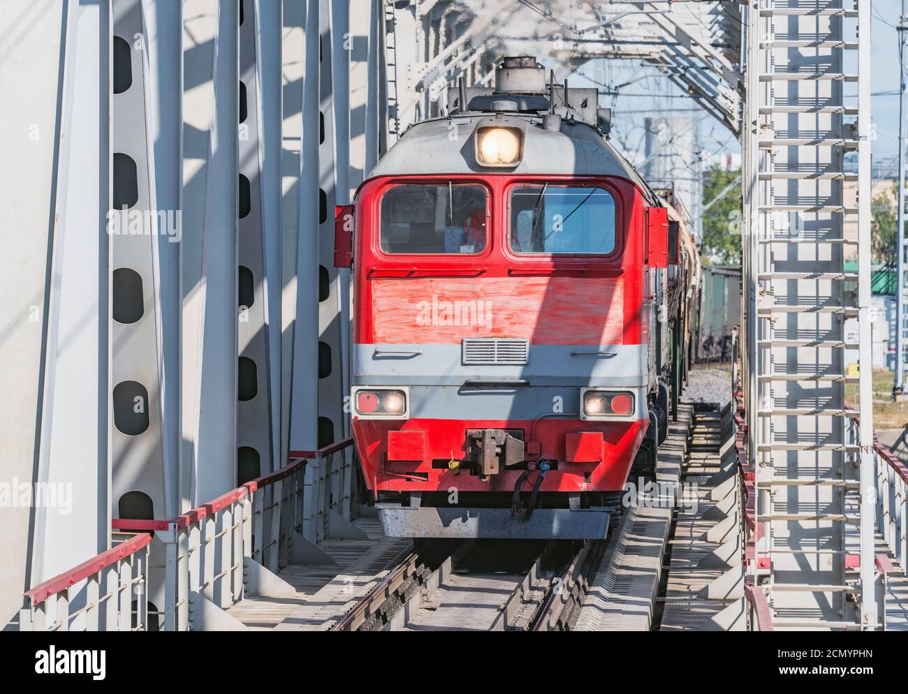 Diesel freight train moves through the bridge Stock Photo - Alamy