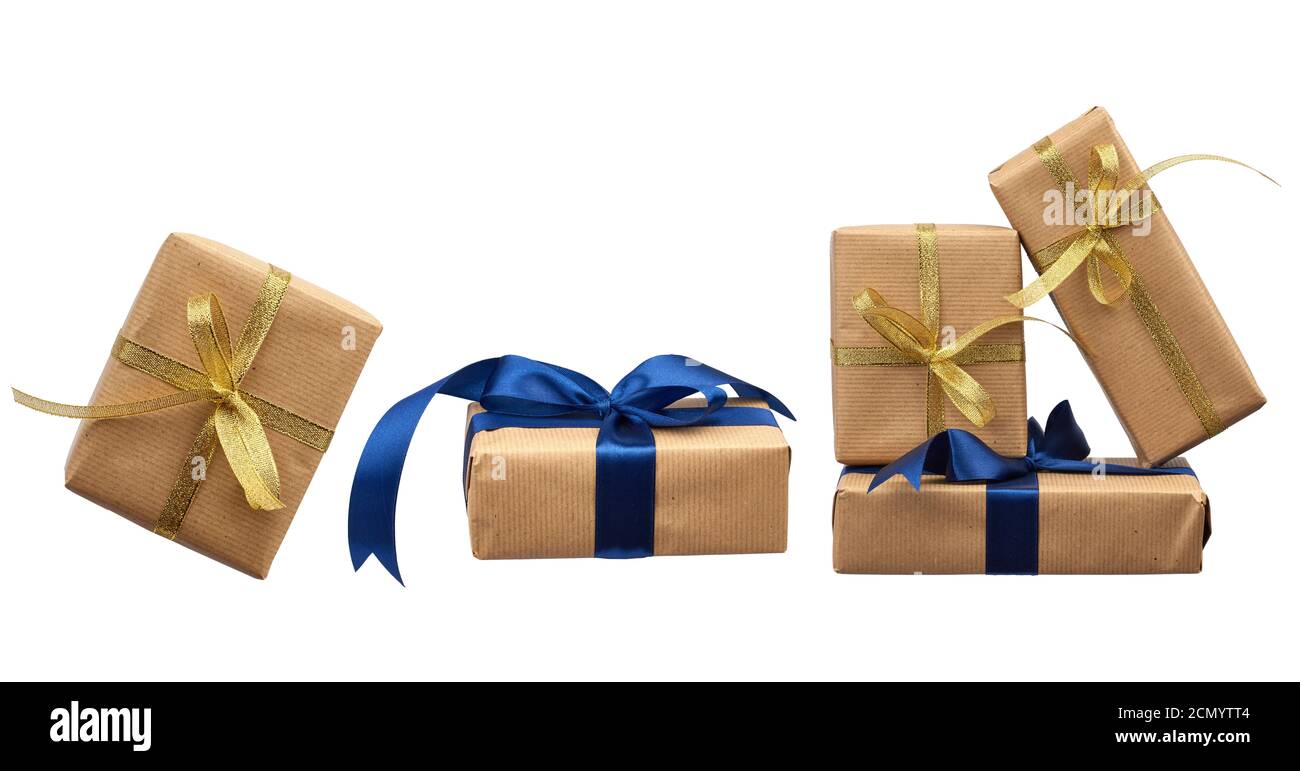 stack of gifts wrapped in brown kraft paper and tied with a silk blue ...
