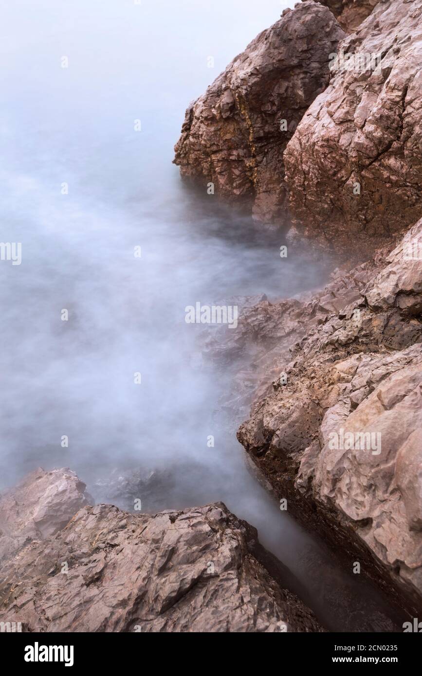 Rocks and waves smooth and soft Stock Photo - Alamy