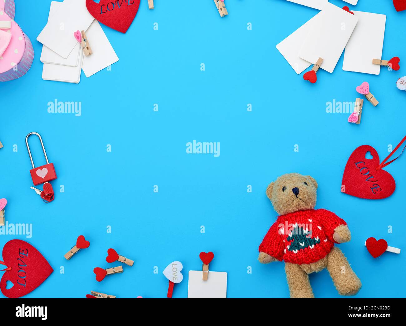 small teddy bear, white blank business cards with clothespins on a blue ...