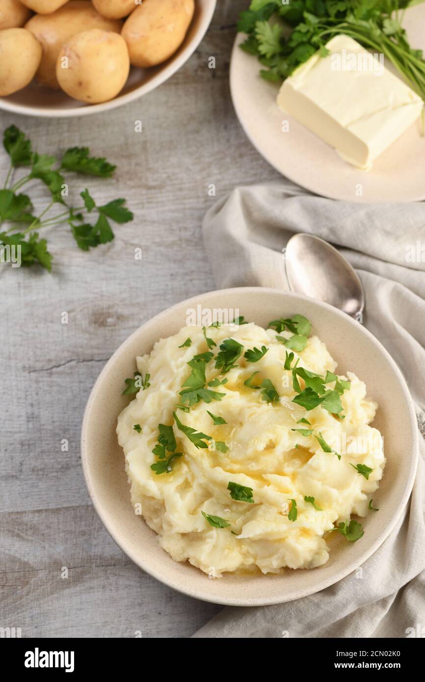 A plate of mashed potatoes poured with melted butter and seasoned with ...