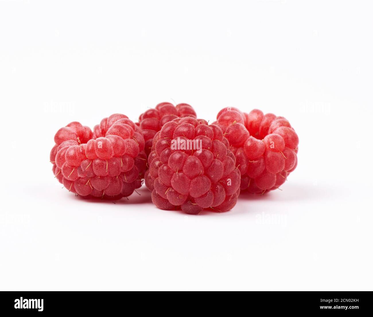 whole ripe red raspberries on a white background Stock Photo - Alamy