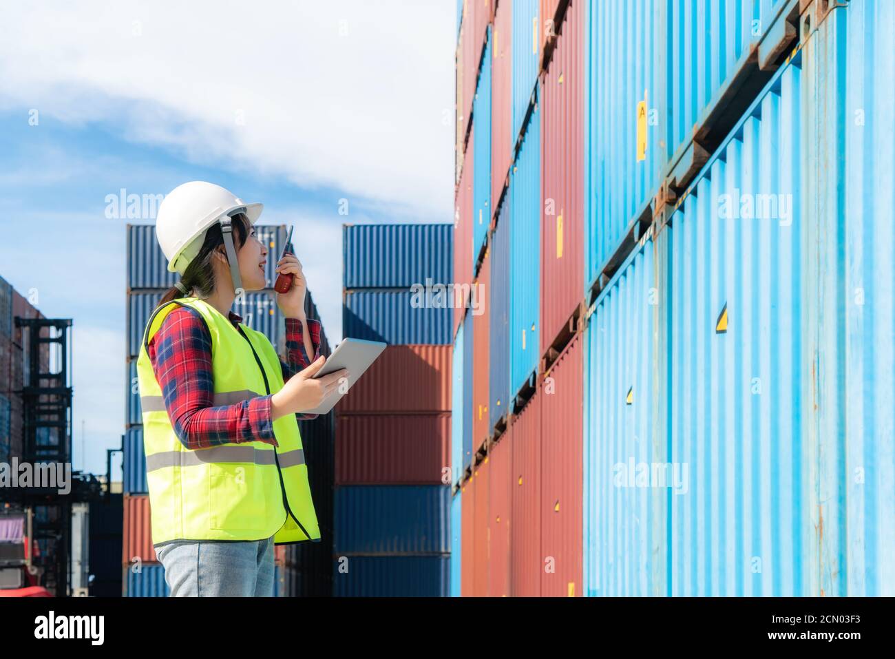 Engineer woman or Foreman manager in container depot working with ...