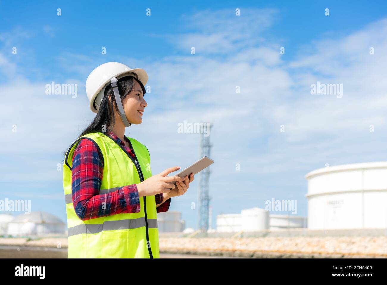 Asian woman petrochemical engineer working with digital tablet Inside ...