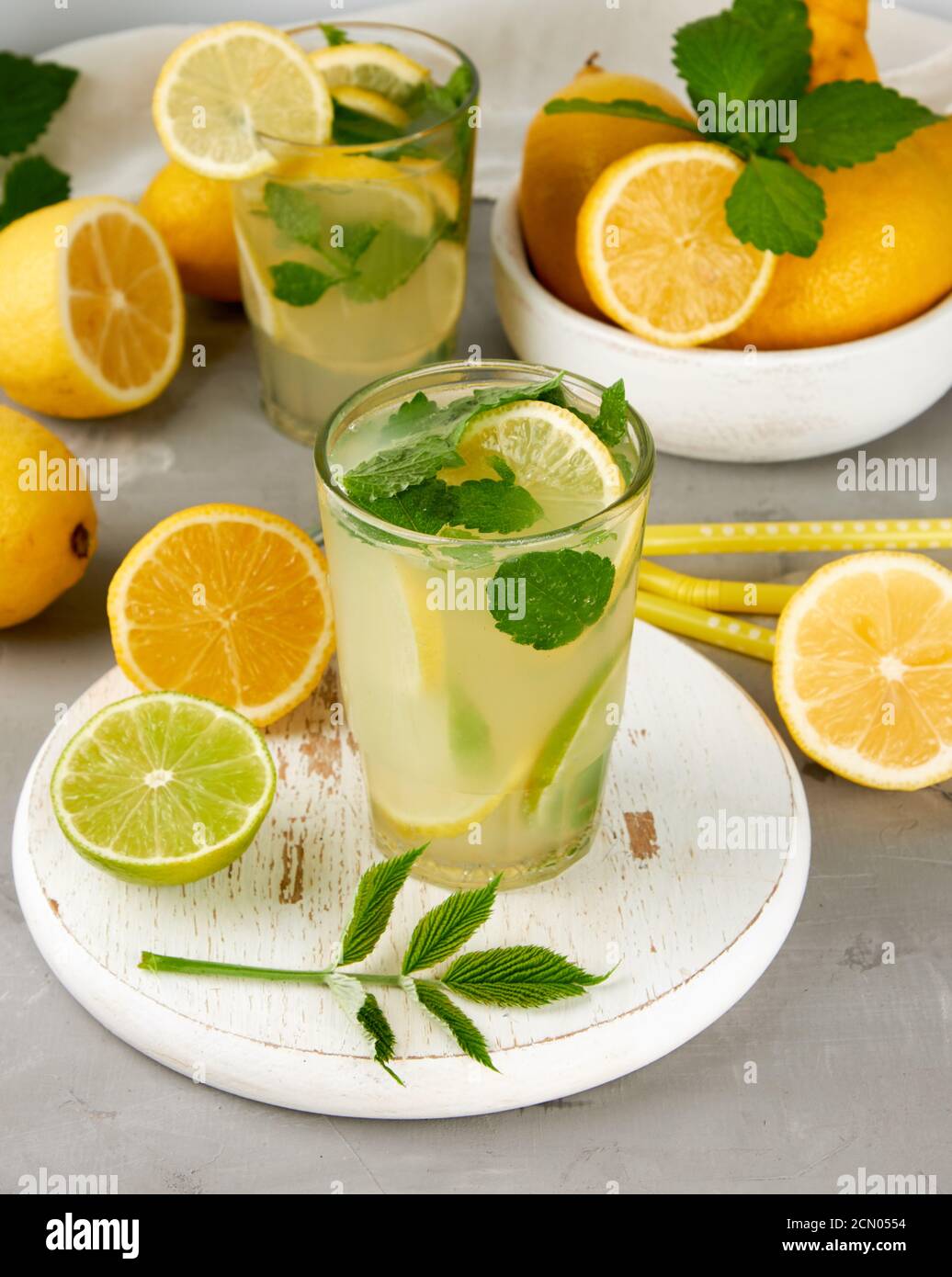 summer refreshing drink lemonade with lemons, mint leaves, lime in a ...