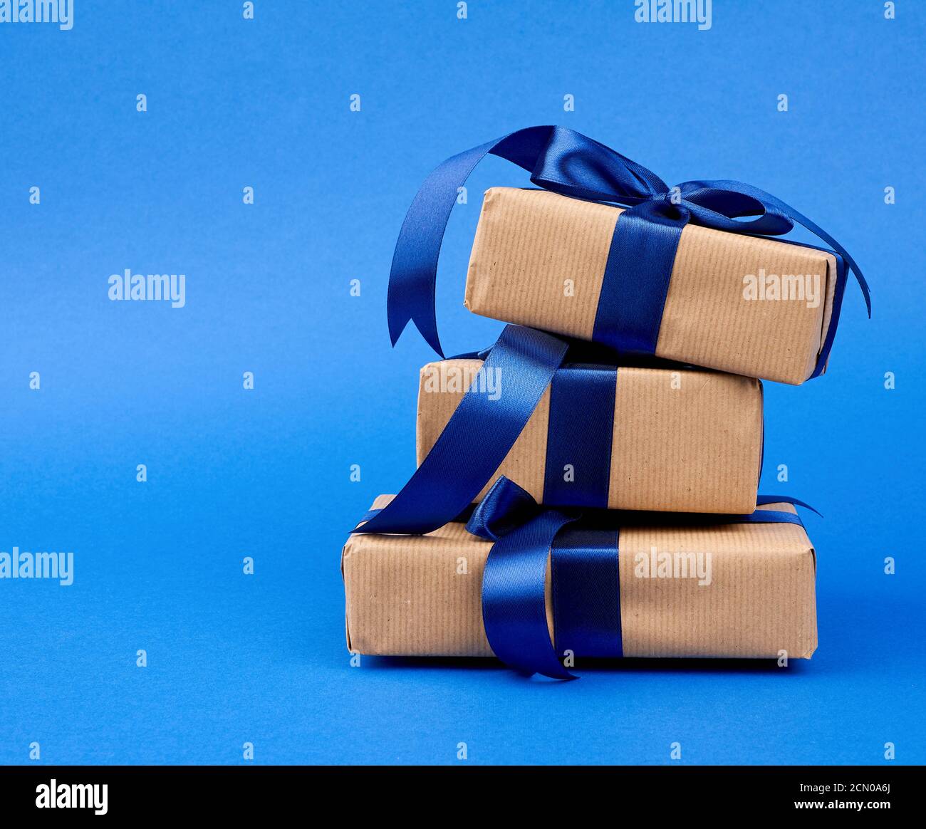 rectangle box wrapped in brown kraft paper and tied with a silk blue ...