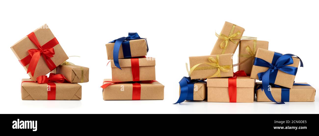 stack of gifts wrapped in brown kraft paper and tied with silk blue and ...
