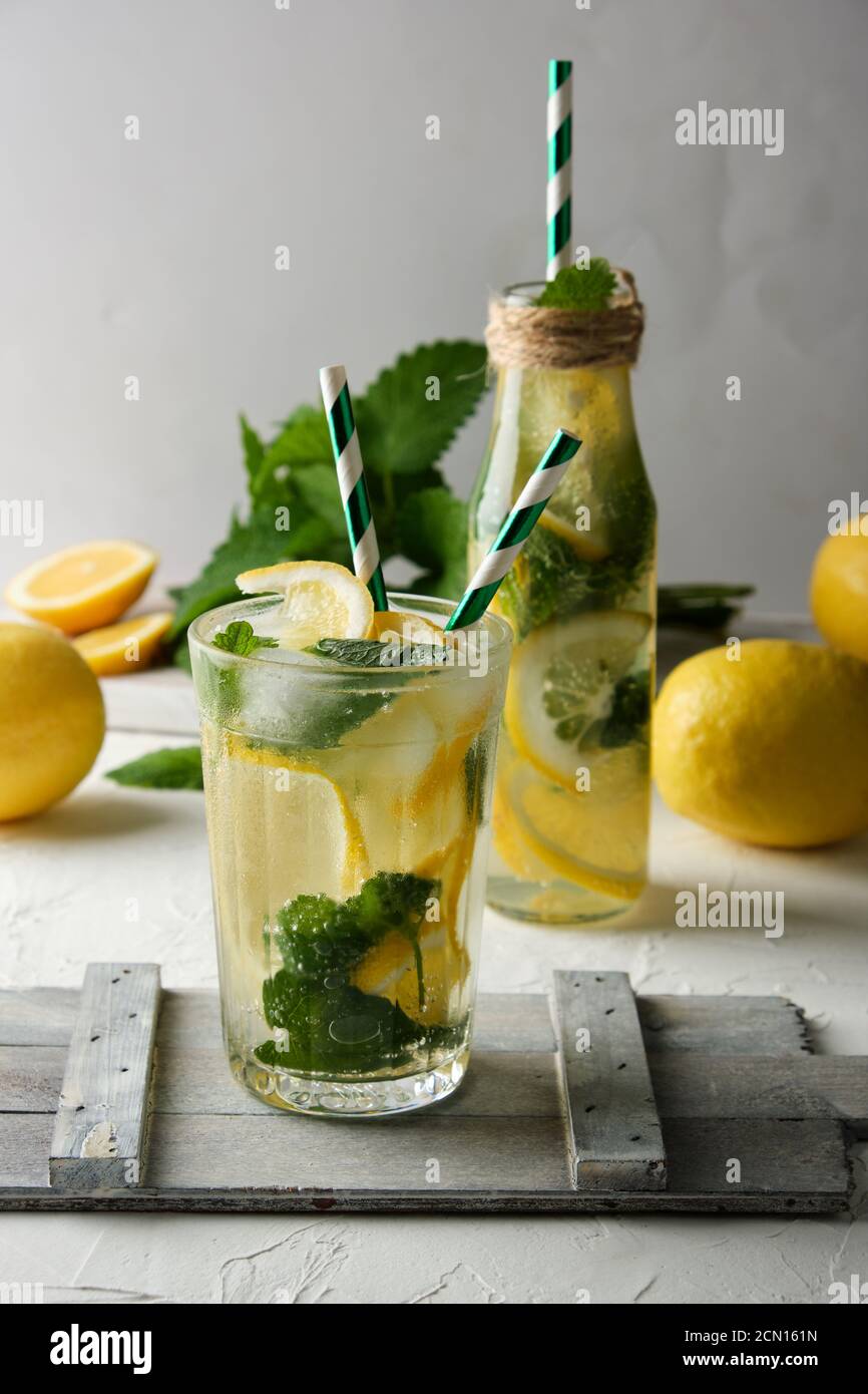 summer refreshing drink lemonade with lemons, mint leaves, lime in a ...