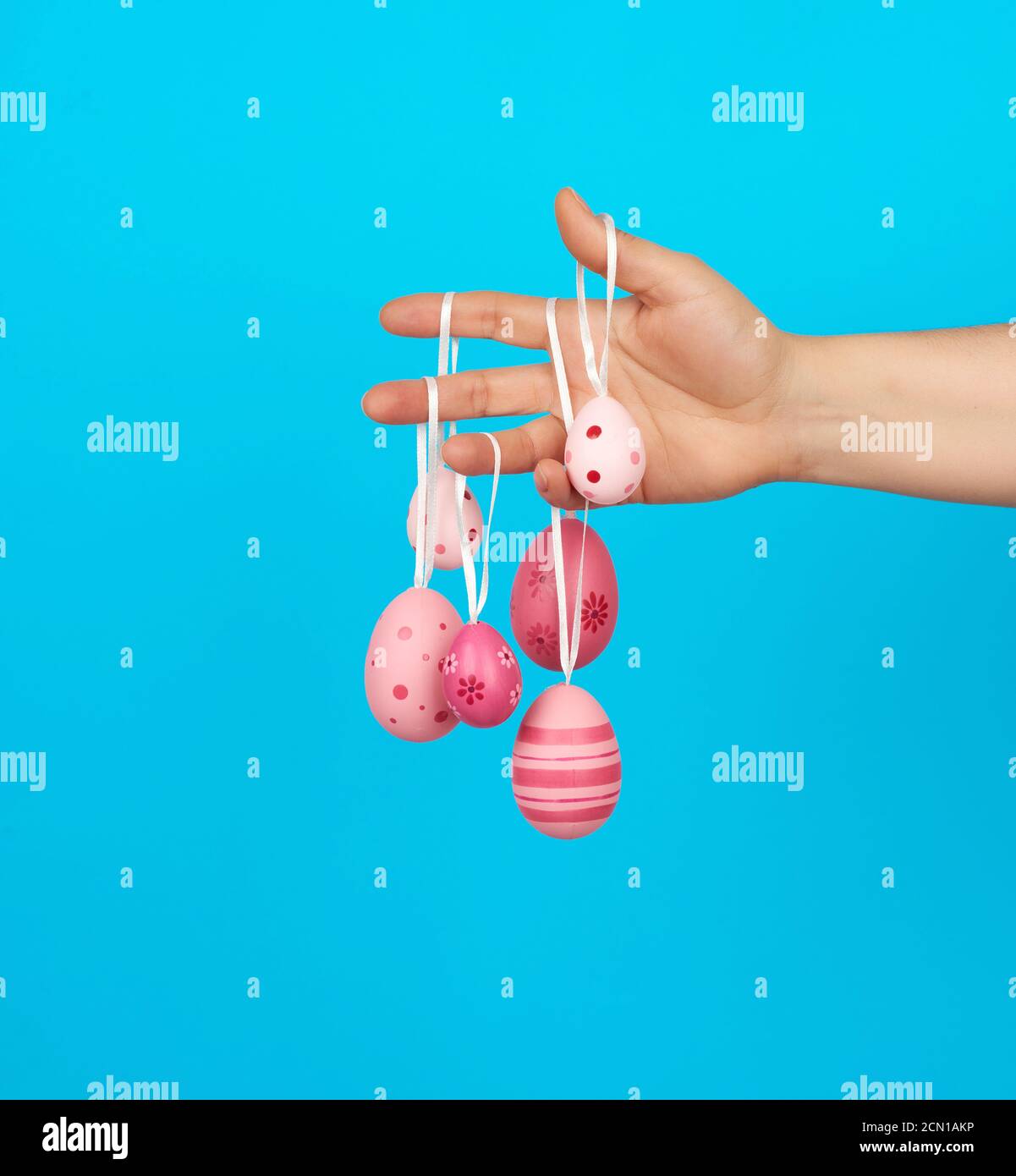 female hand holds easter colored pink eggs on a rope Stock Photo - Alamy