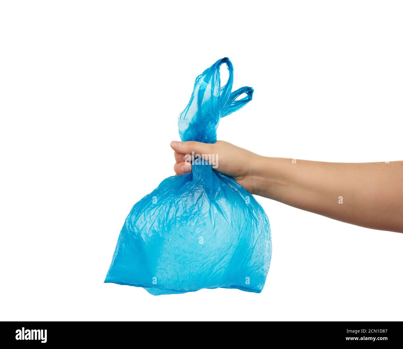 hand holds an empty blue plastic bag on a white background, concept of ...
