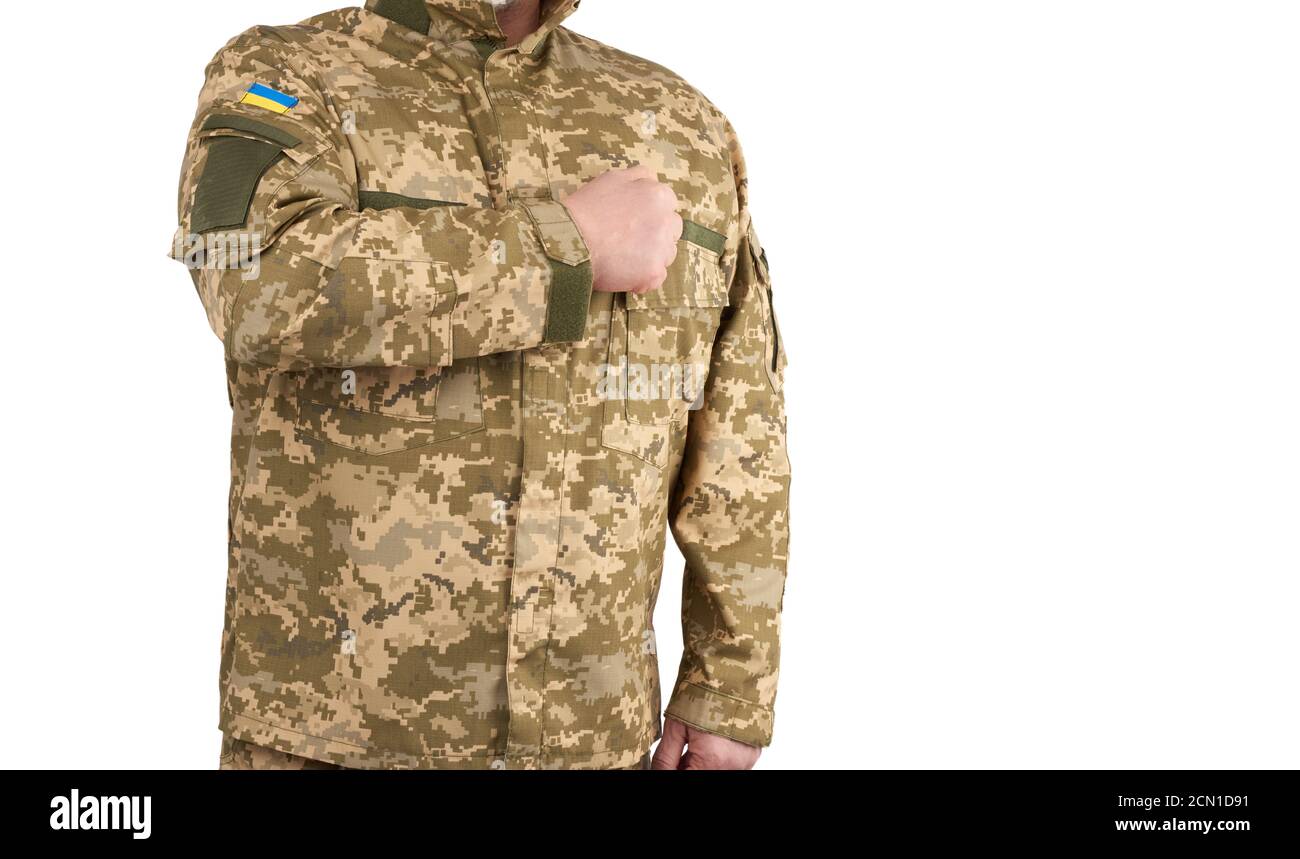 Ukrainian man warrior dressed in a military pixel uniform stands on a ...