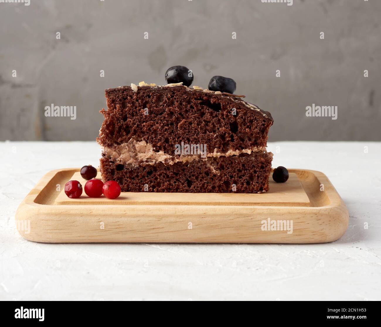 triangular piece of chocolate biscuit cake with butter cream Stock ...