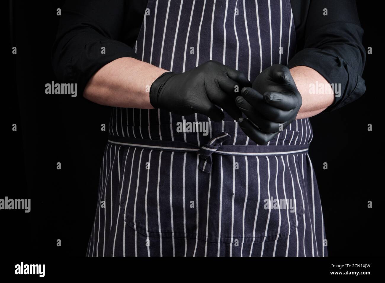Cook hand in black rubber hi-res stock photography and images - Alamy