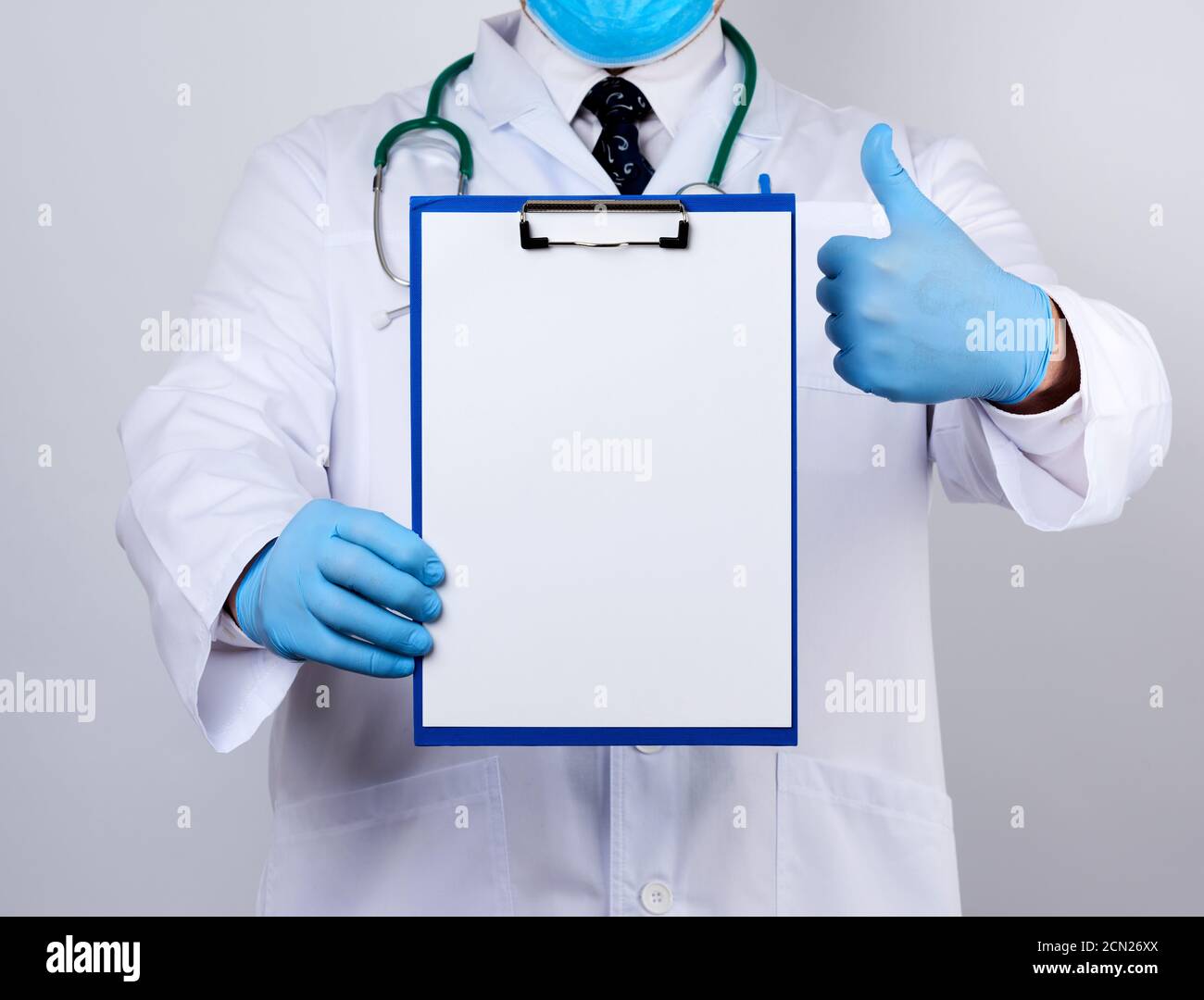 doctor holding a paper holder with a white blank sheet Stock Photo - Alamy