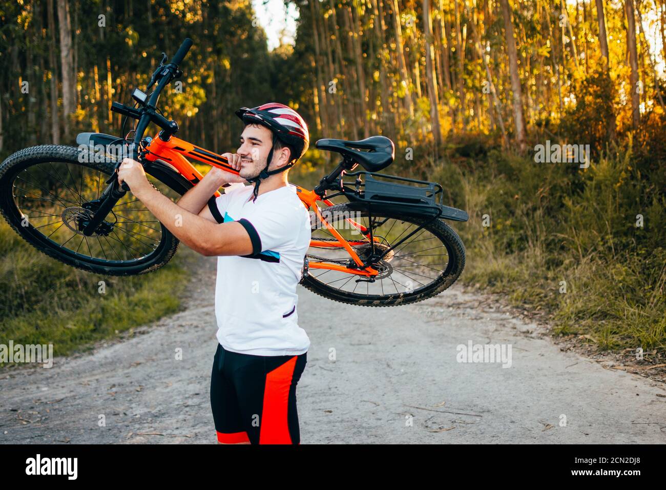 Young man carrying his bike hi-res stock photography and images - Alamy