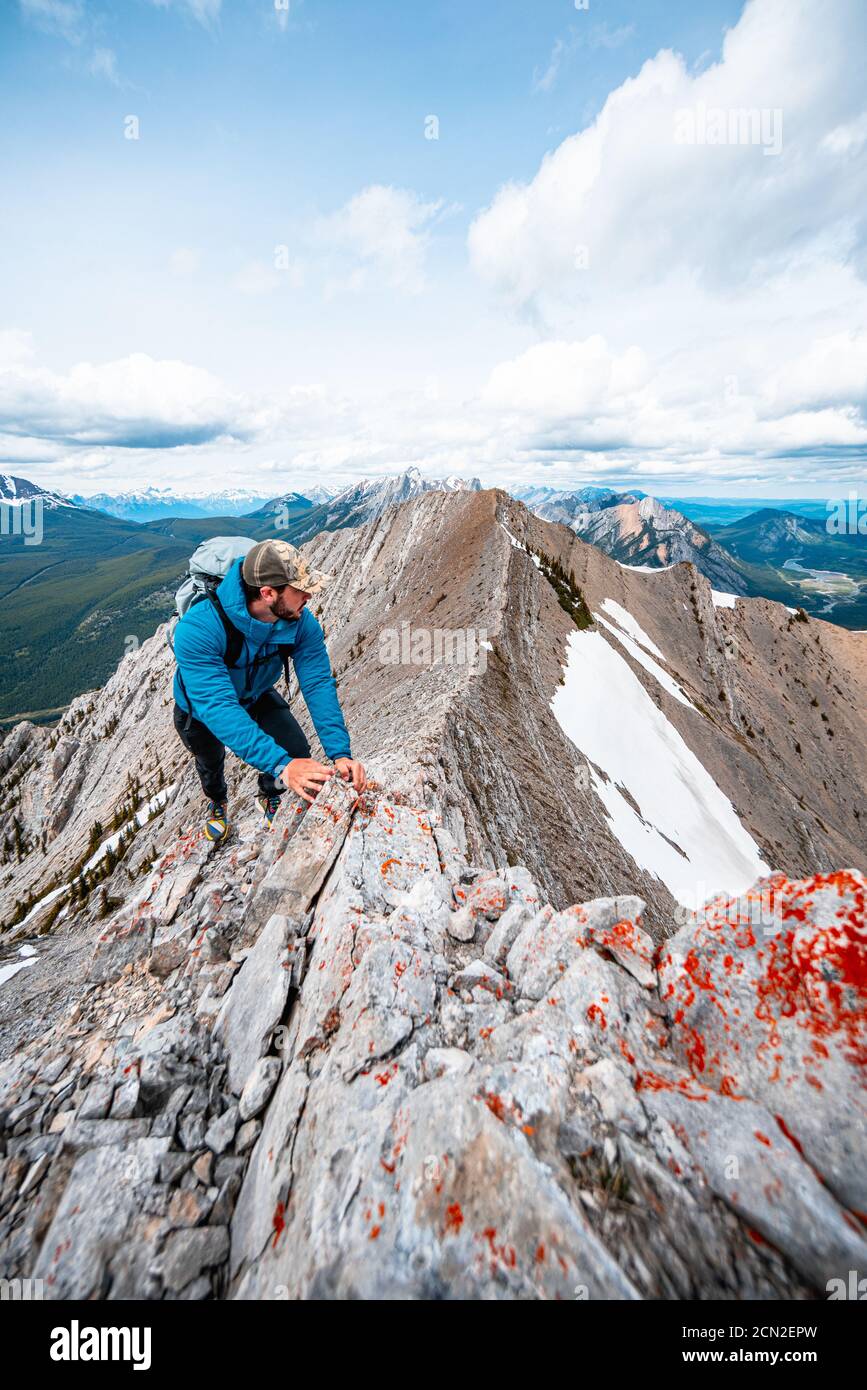 Mountain Runner Scrambling up Mountain Ridge in Canadian Rockies Stock ...