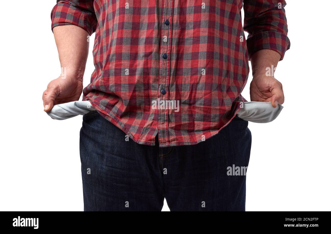 man in a red shirt turned out the empty pockets of his pants Stock ...