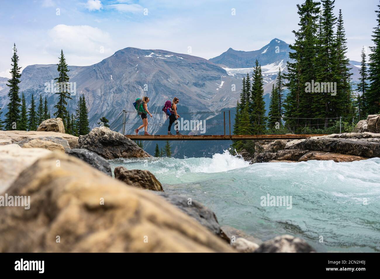 Hikers Crossing Glacial River Over Twin Falls Along the Whaleback Stock ...