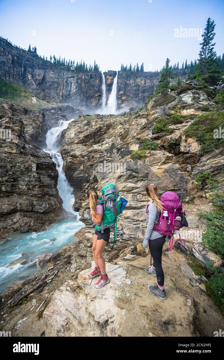 Two Hikers Admiring Twin Falls Waterfall In Yoho National Park Stock ...