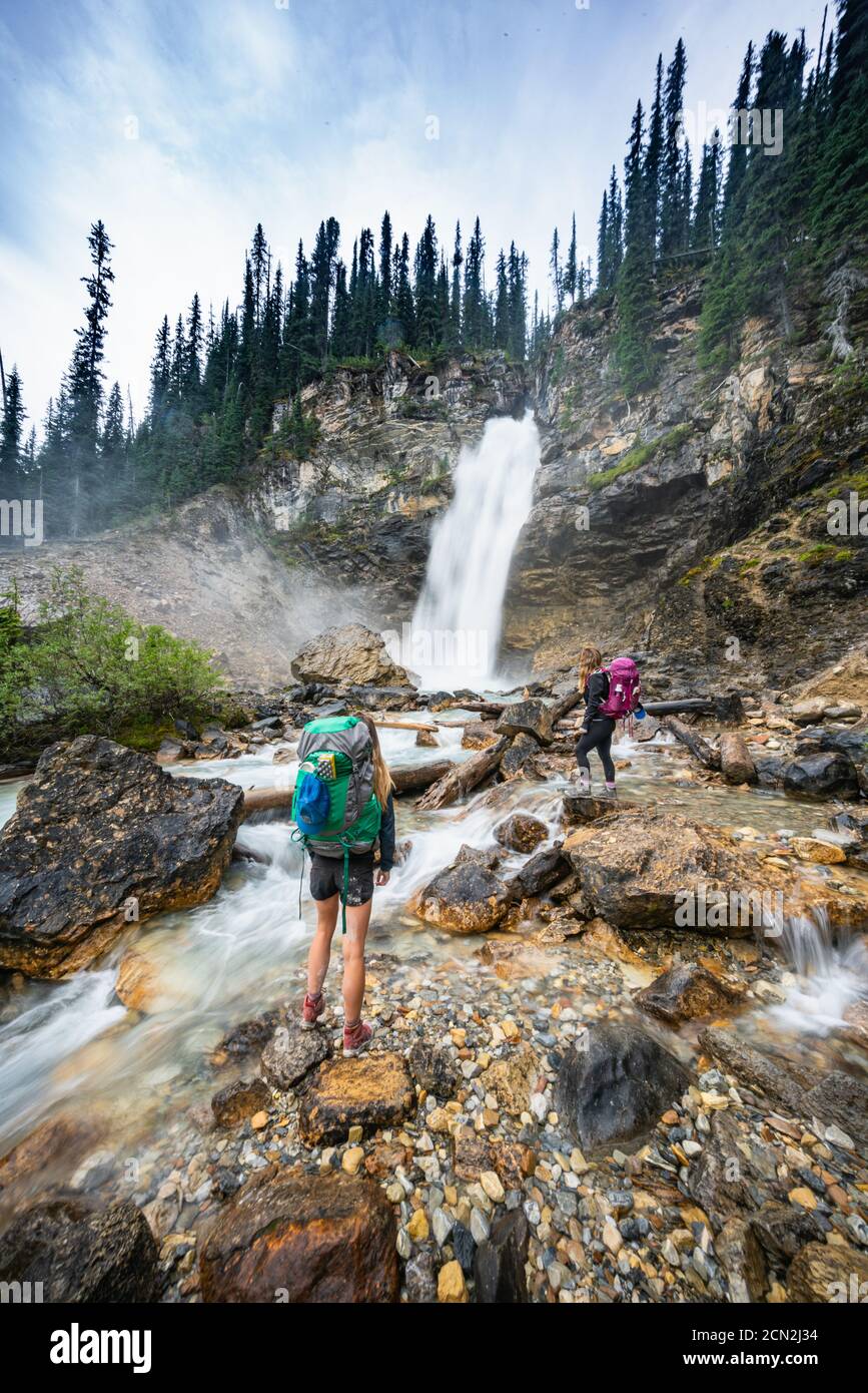 Hikers Standing Alongside Laughing Falls Waterfall in Yoho Stock Photo ...