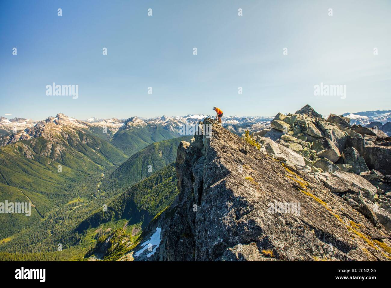 Hiker approaches mountain summit with amazing view Stock Photo - Alamy