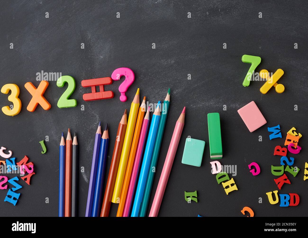 wooden multi-colored pencils, plastic numbers on a black background ...