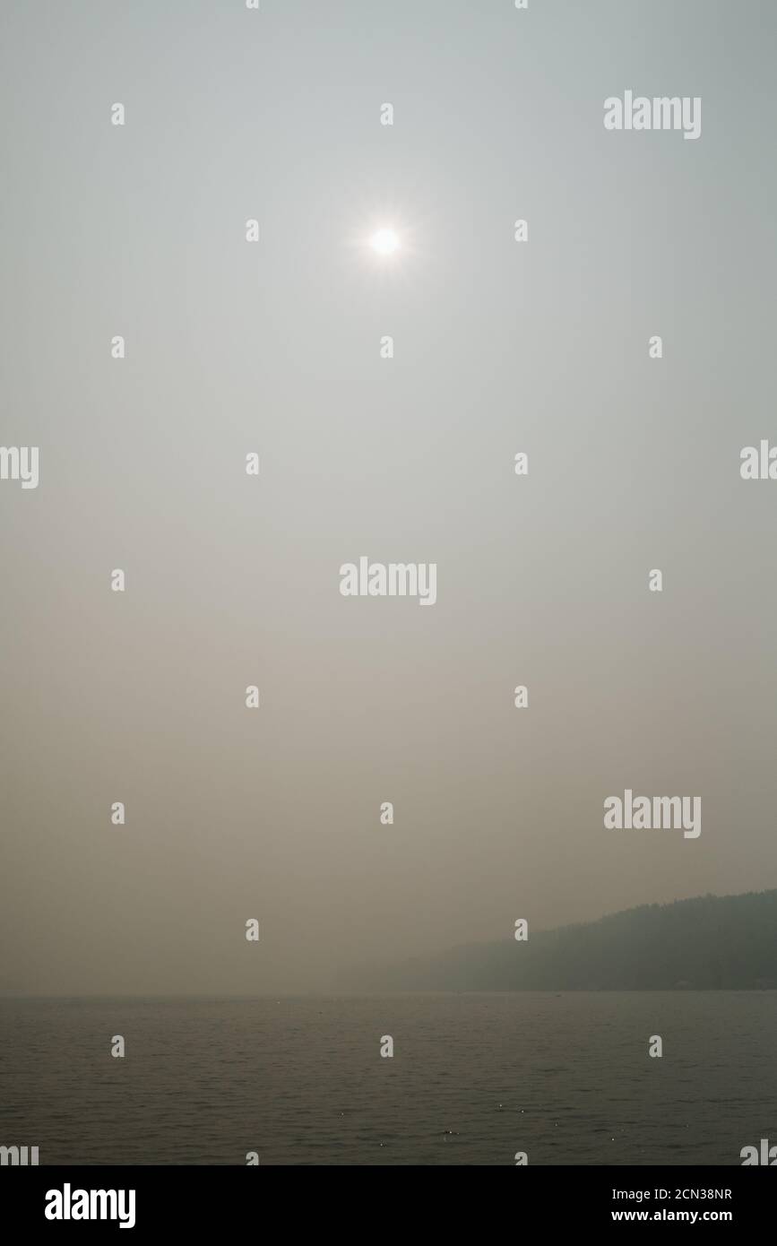 View of the sun, blocked by wildfire smoke, over Puget Sound Stock ...