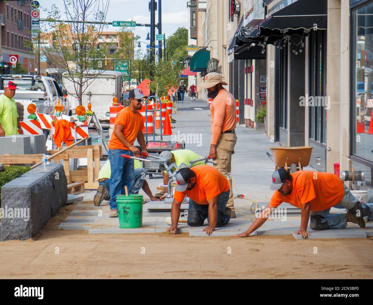 Construction workers laying pavement blocks. Lake Street Reconstruction ...
