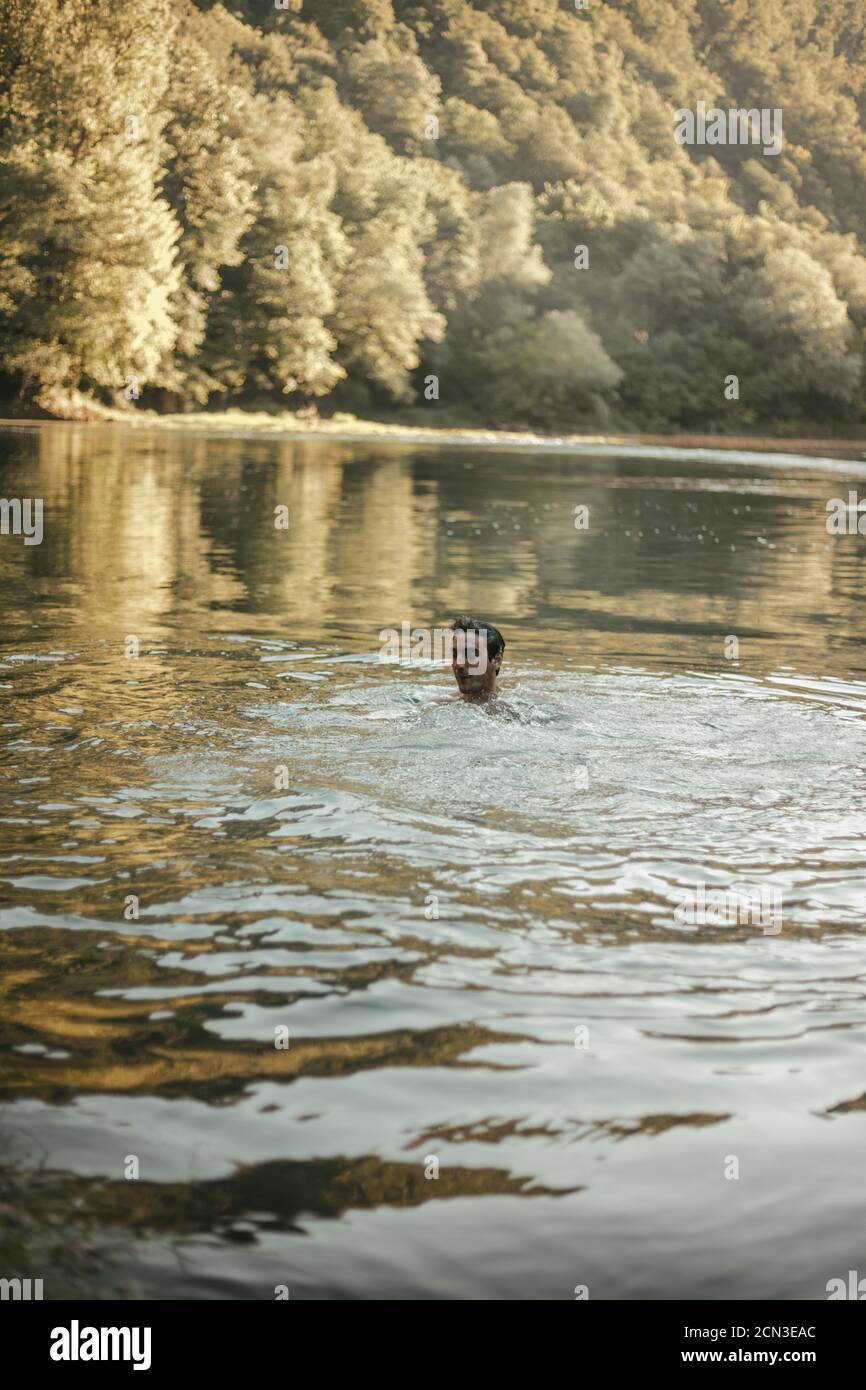 Young man bathing in the river Stock Photo - Alamy