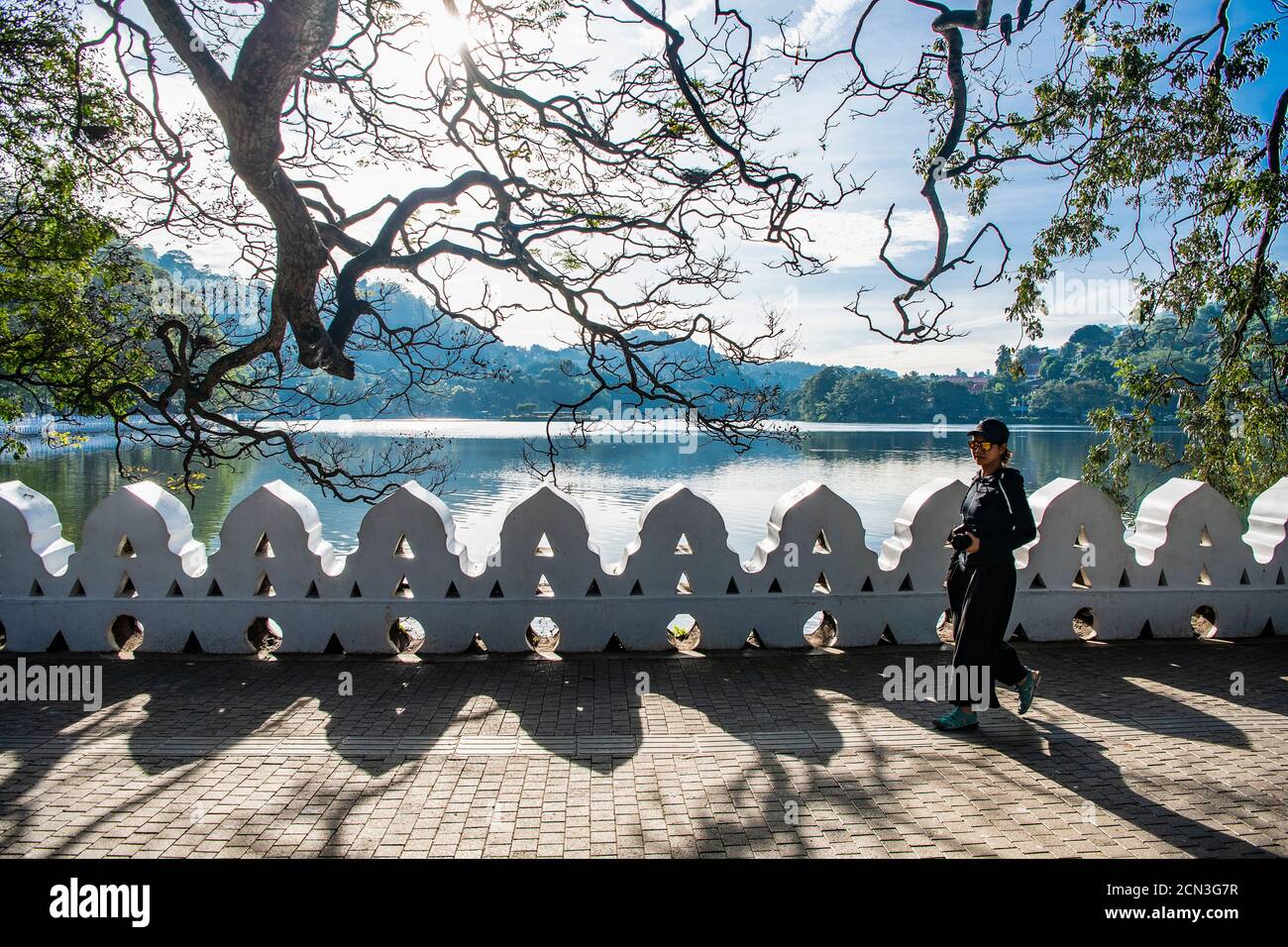 Woman walking along lake Kandy in Sri Lanka Stock Photo - Alamy